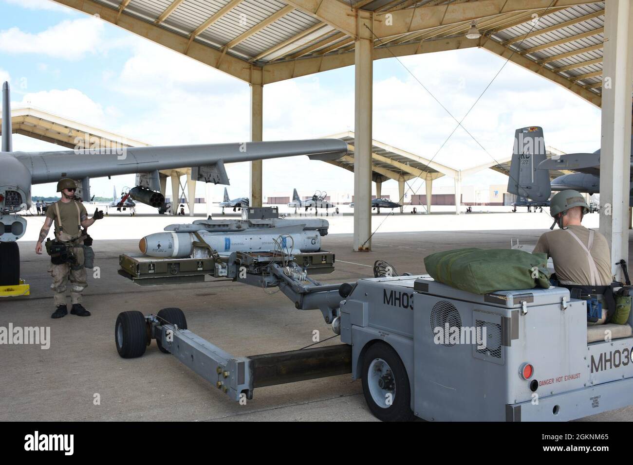 Weapons troops from the 442d Munitions Squadron load practice bombs ...