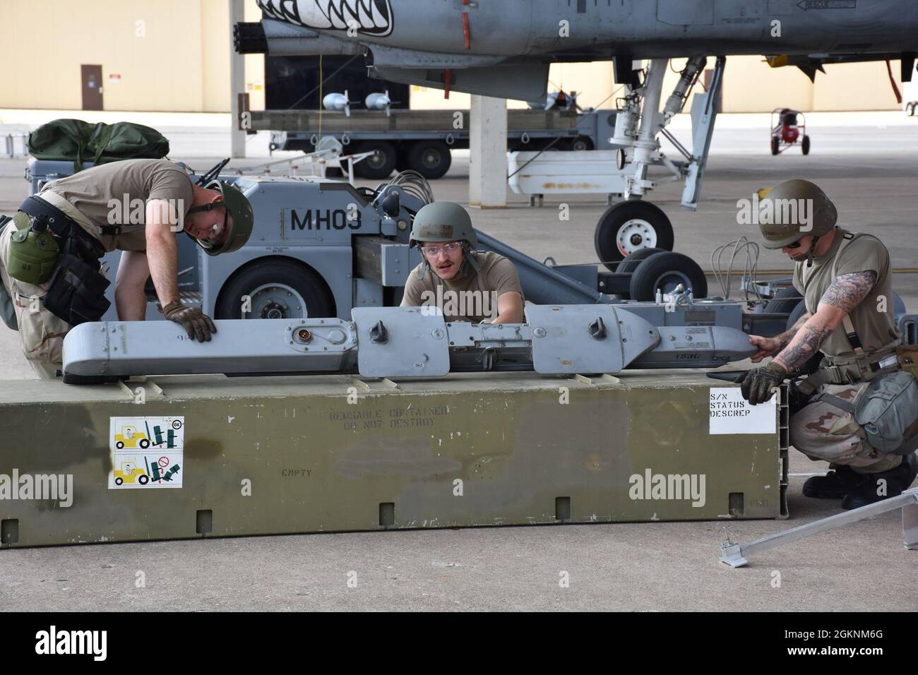 Weapons troops from the 442d Munitions Squadron load practice bombs ...