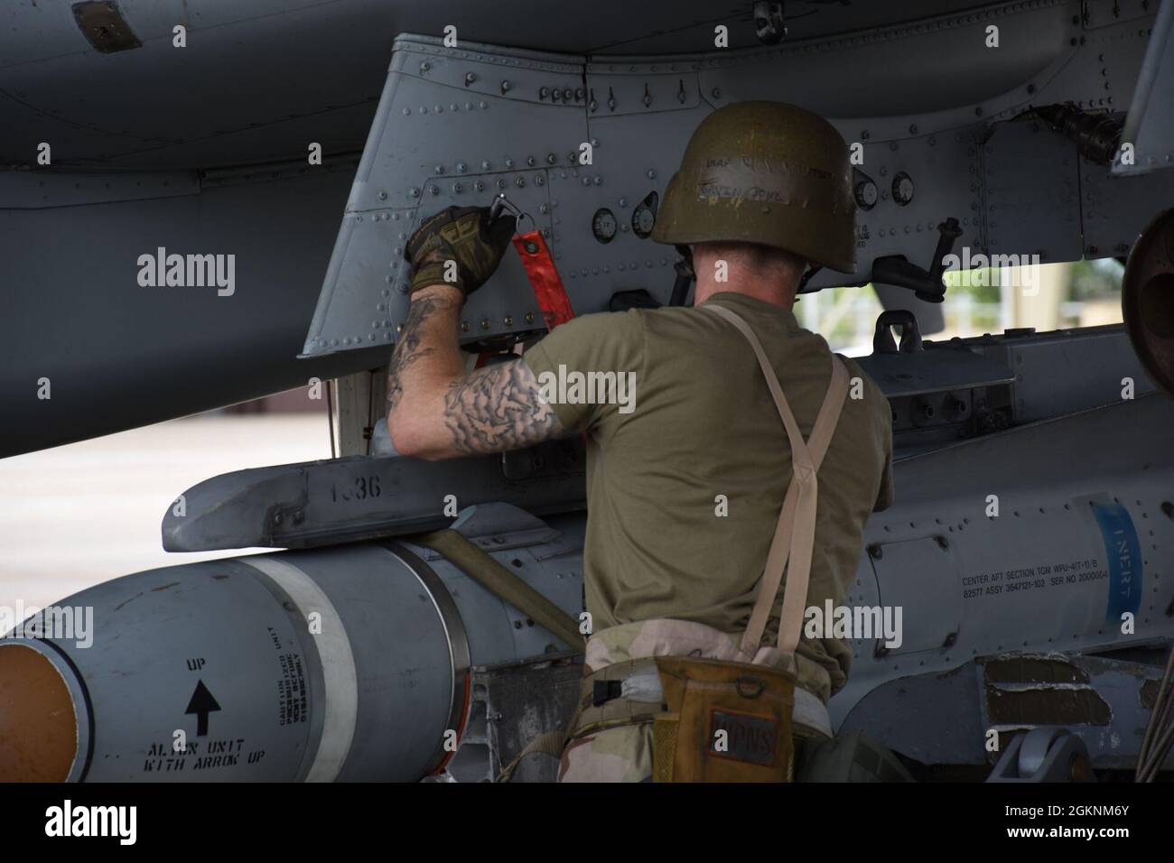 Weapons troops from the 442d Munitions Squadron load practice bombs ...