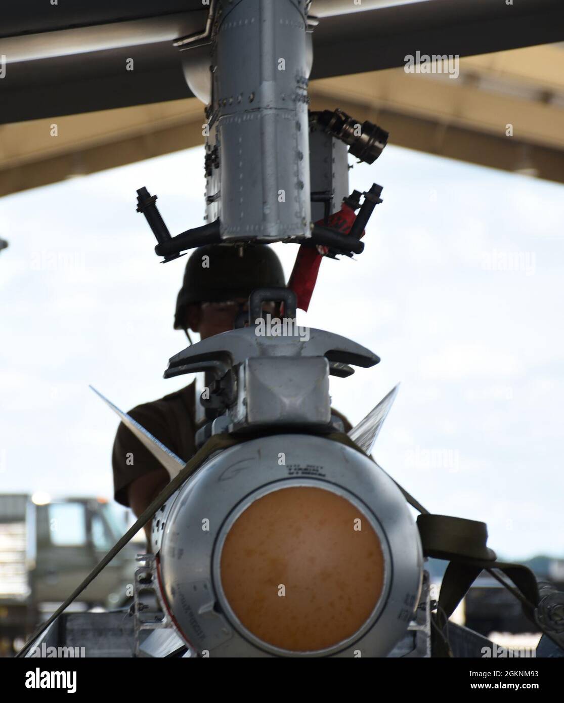 Weapons troops from the 442d Munitions Squadron load practice bombs ...