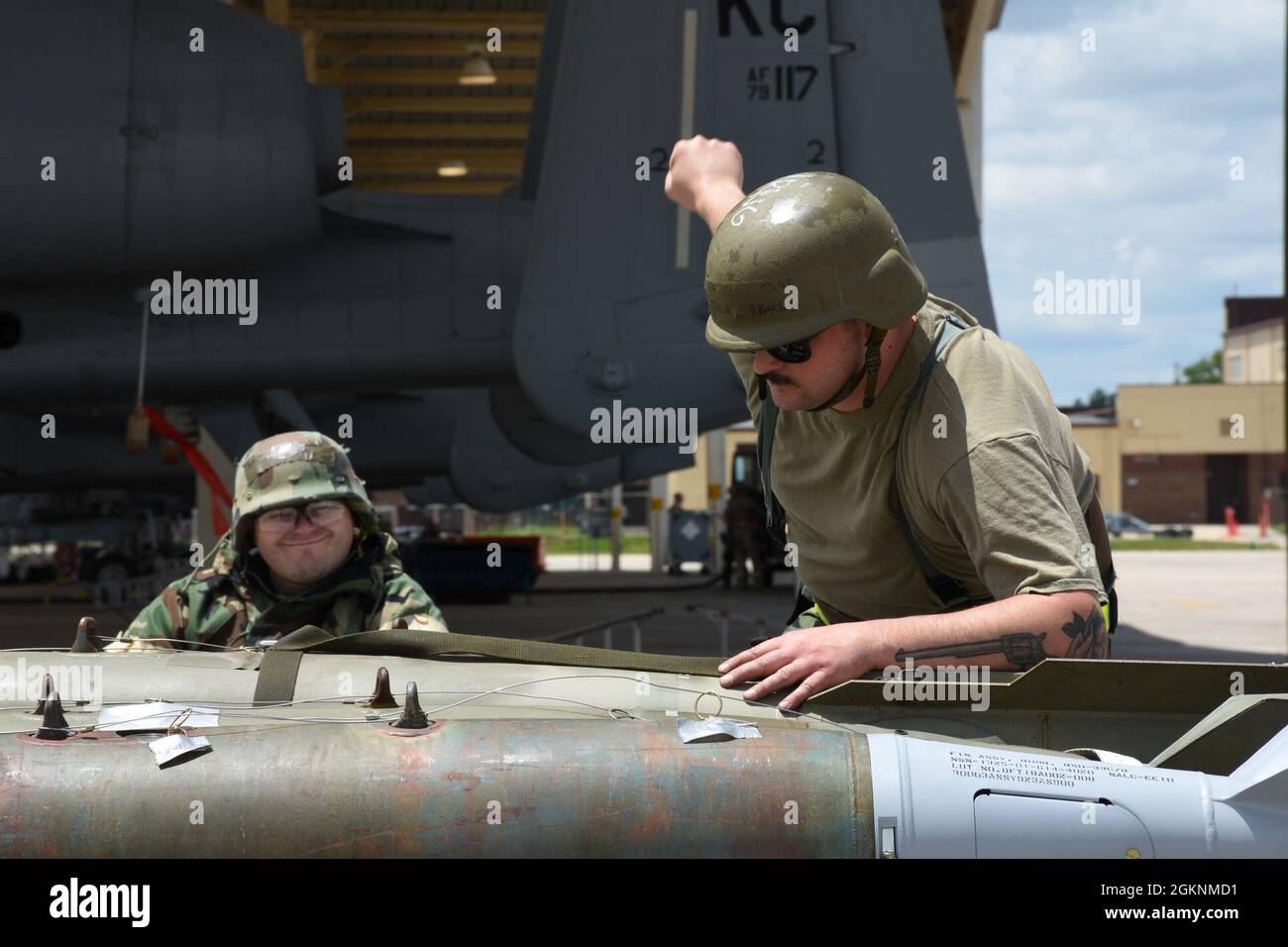 Weapons troops from the 442d Munitions Squadron load practice bombs ...