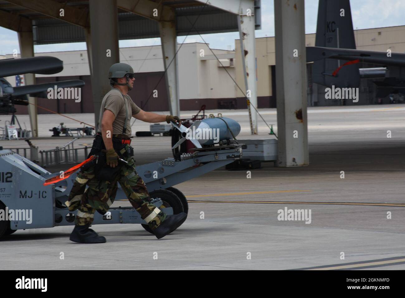 Weapons troops from the 442d Munitions Squadron load practice bombs ...