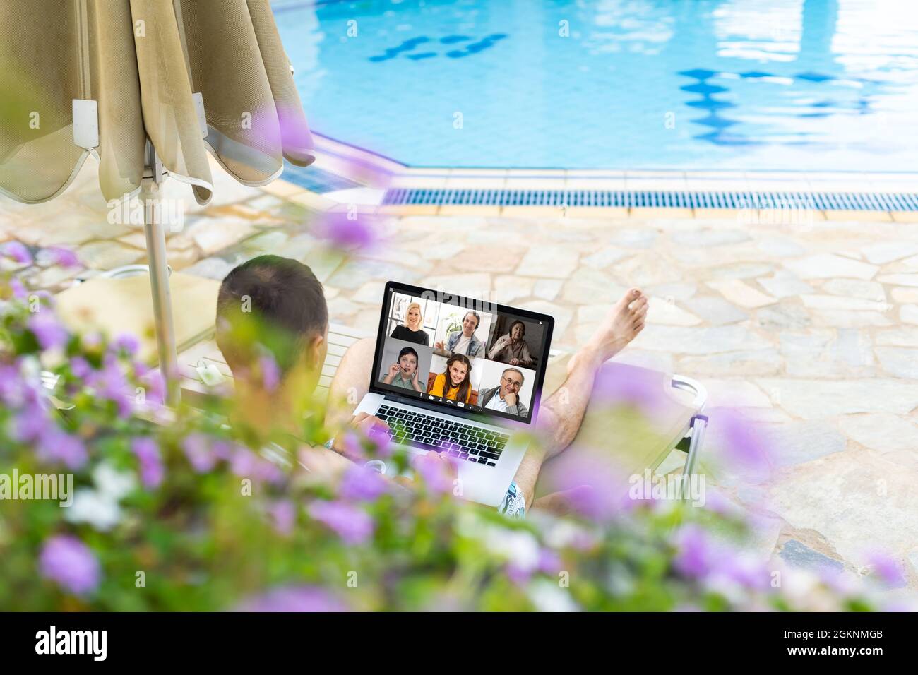 man using a laptop near the pool Stock Photo - Alamy