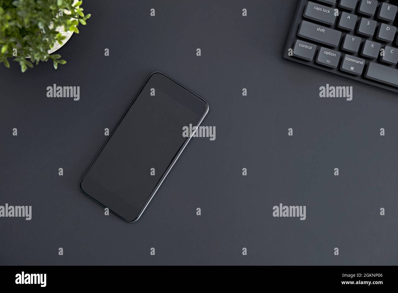 Top down view of mobile phone with black blank screen laying on desk ...