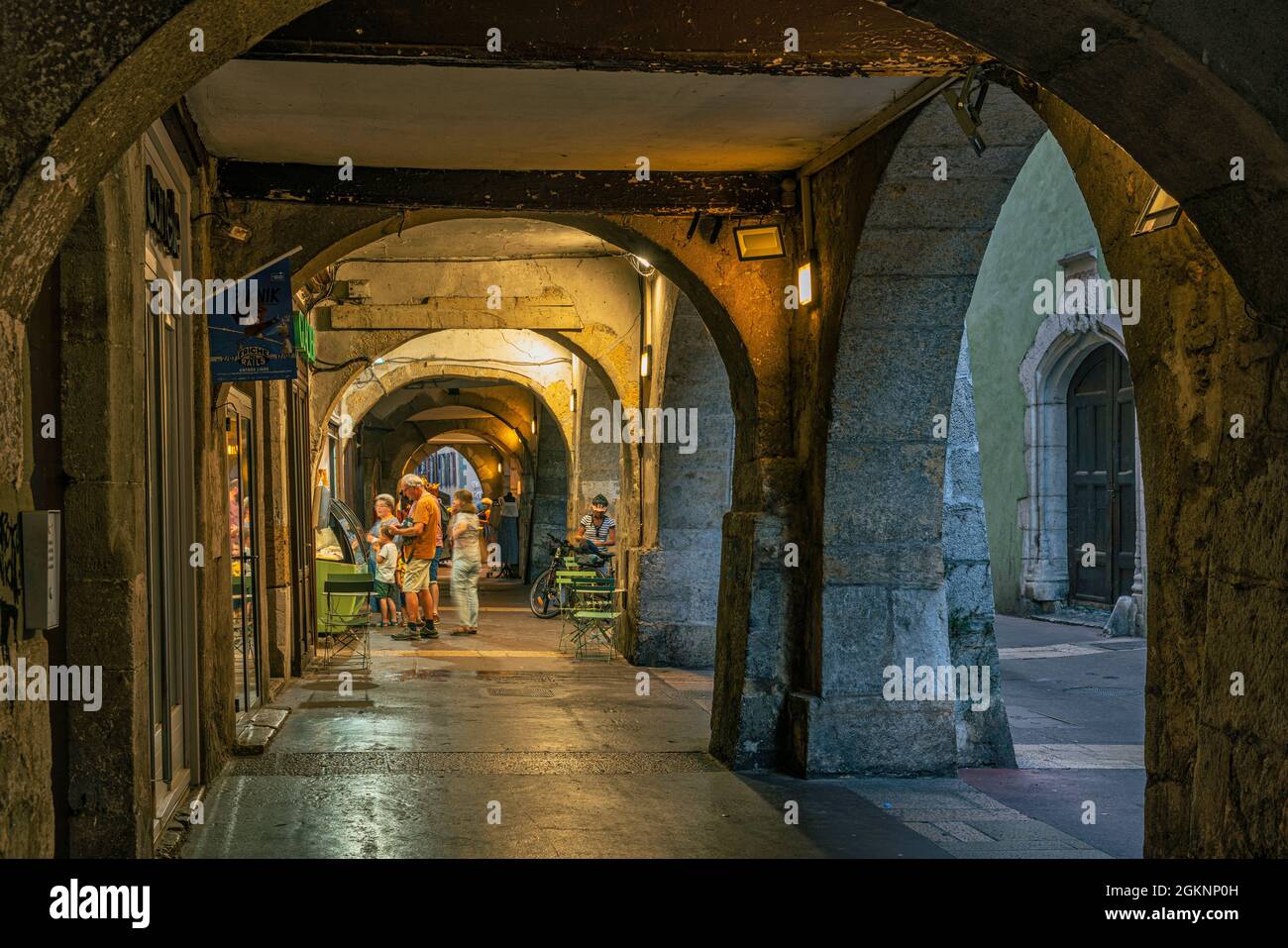 Under the arches of the arcades of the ancient streets of the historic ...