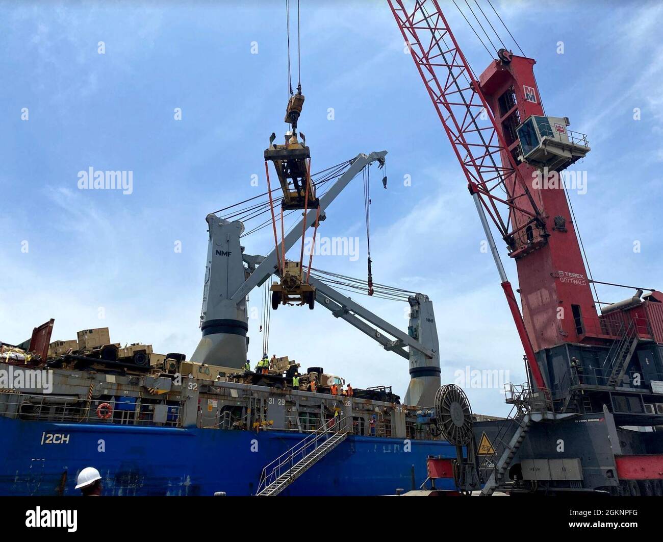 A U.S. Army generator is craned off the cargo ship Ocean Gladiator in ...
