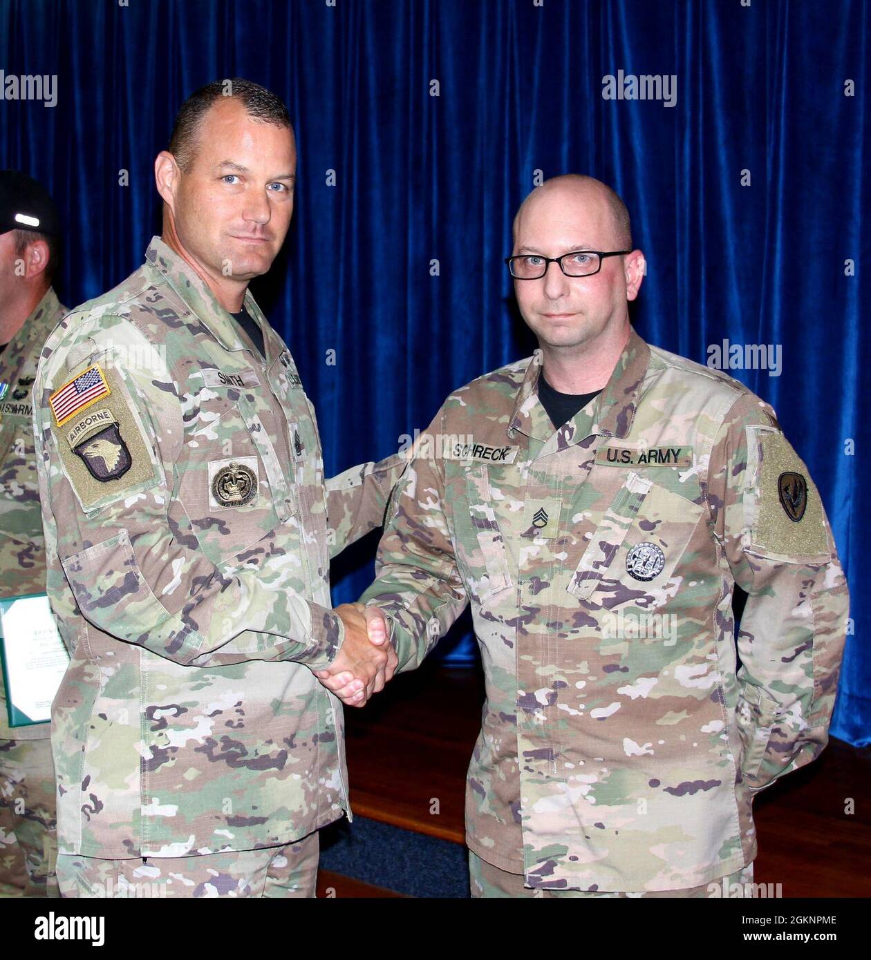 U.S. Army Staff Sgt. David Schreck is presented the Basic Army ...