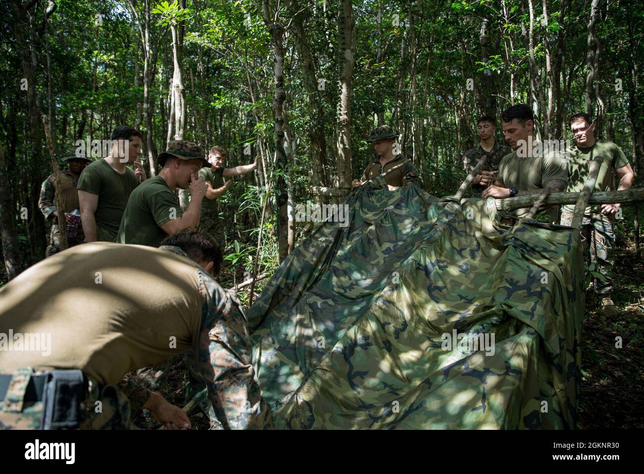 U.S. Air Force Tech Sgt. Casey Carter, left front, a survival, evasion ...