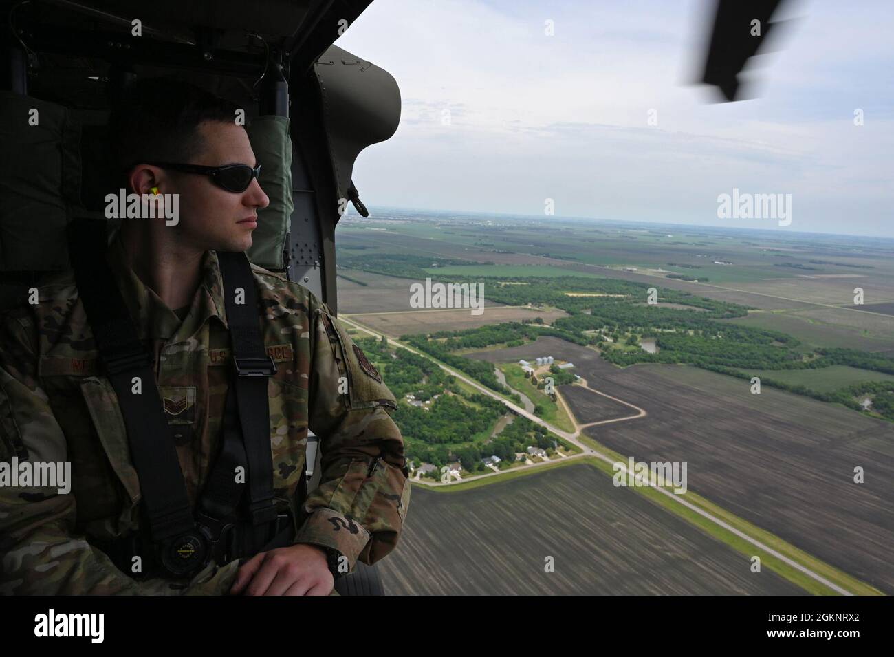 An Airman sits in a North Dakota Army National Guard UH-60 helicopter ...