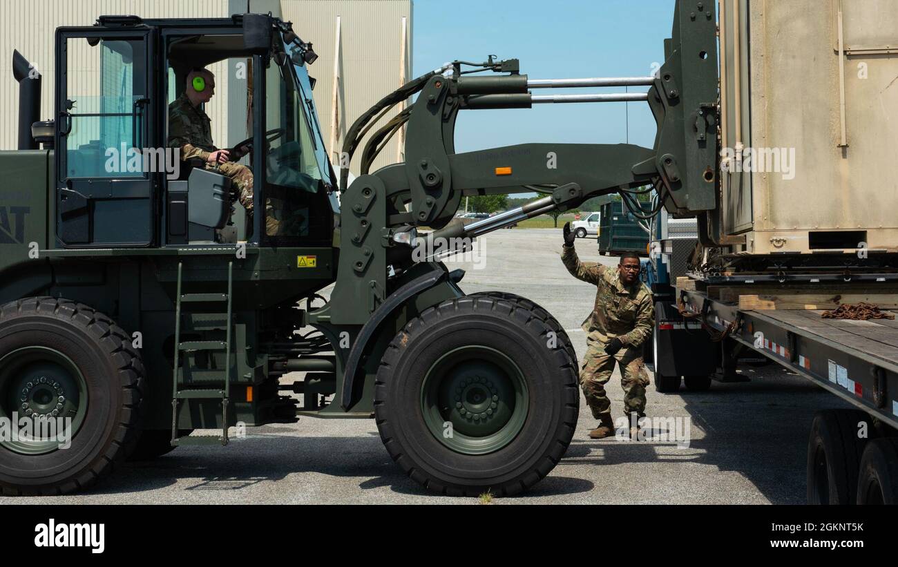 Members of the 102nd Logistics Readiness Flight load cargo on Otis Air ...