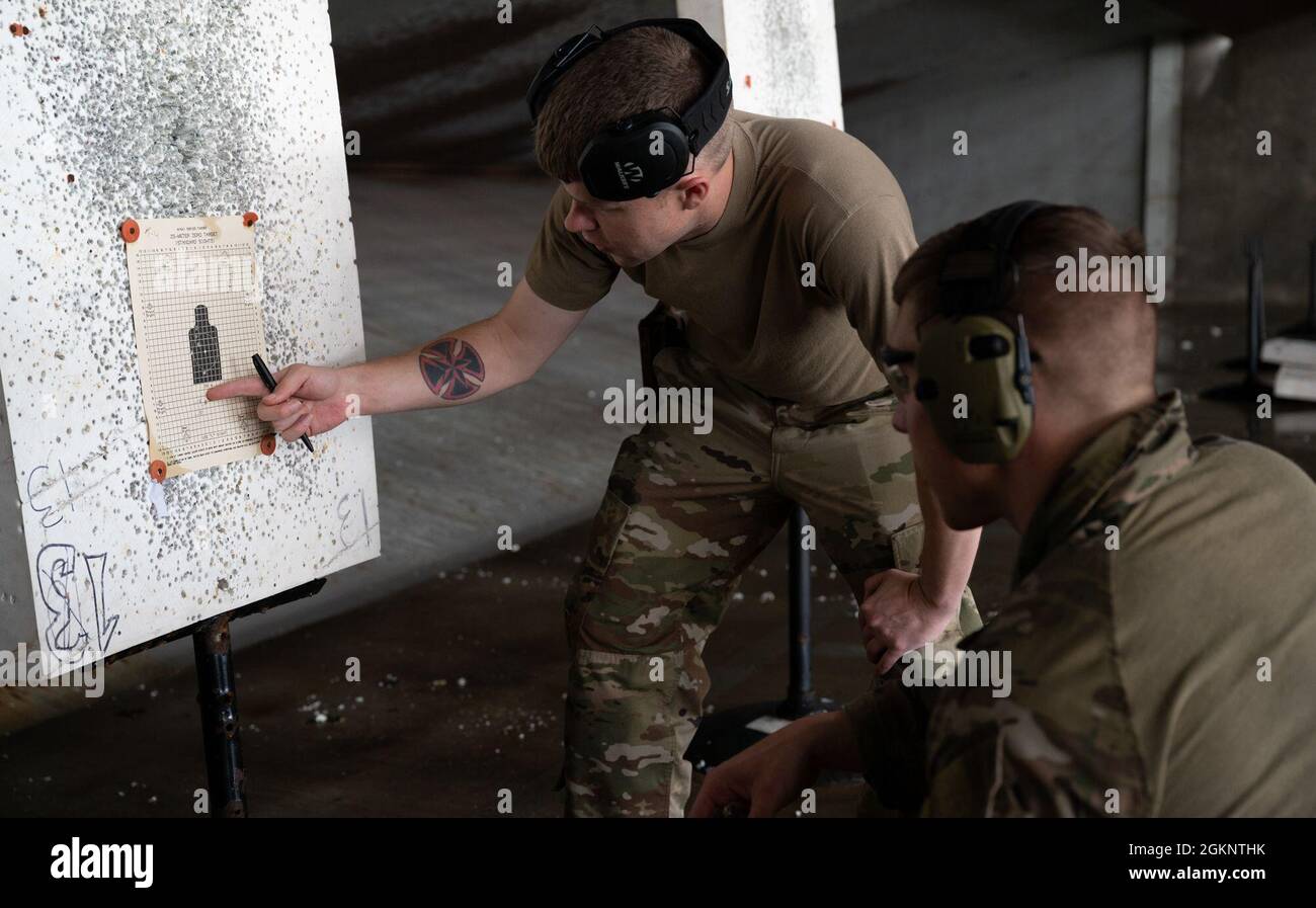 Airmen from the 2nd Security Forces Squadron review weapon markings on ...
