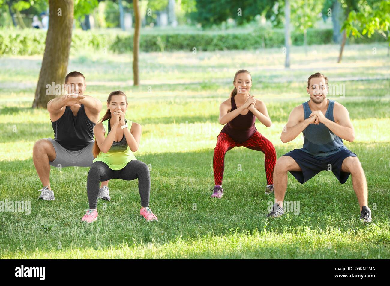 Group of young people doing exercise outdoors Stock Photo - Alamy