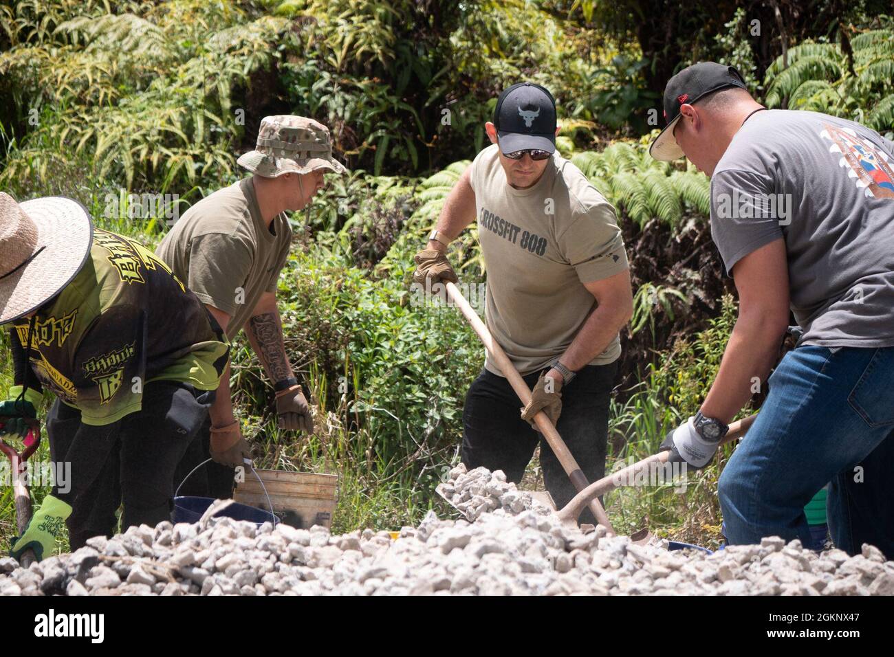 Volunteers from the 154th Security Forces Squadron transport gravel in ...