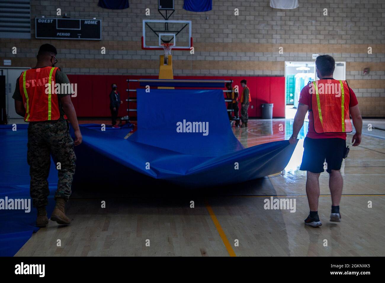 U.S. Marines and civilians prepare Paige Fieldhouse to act as an ...