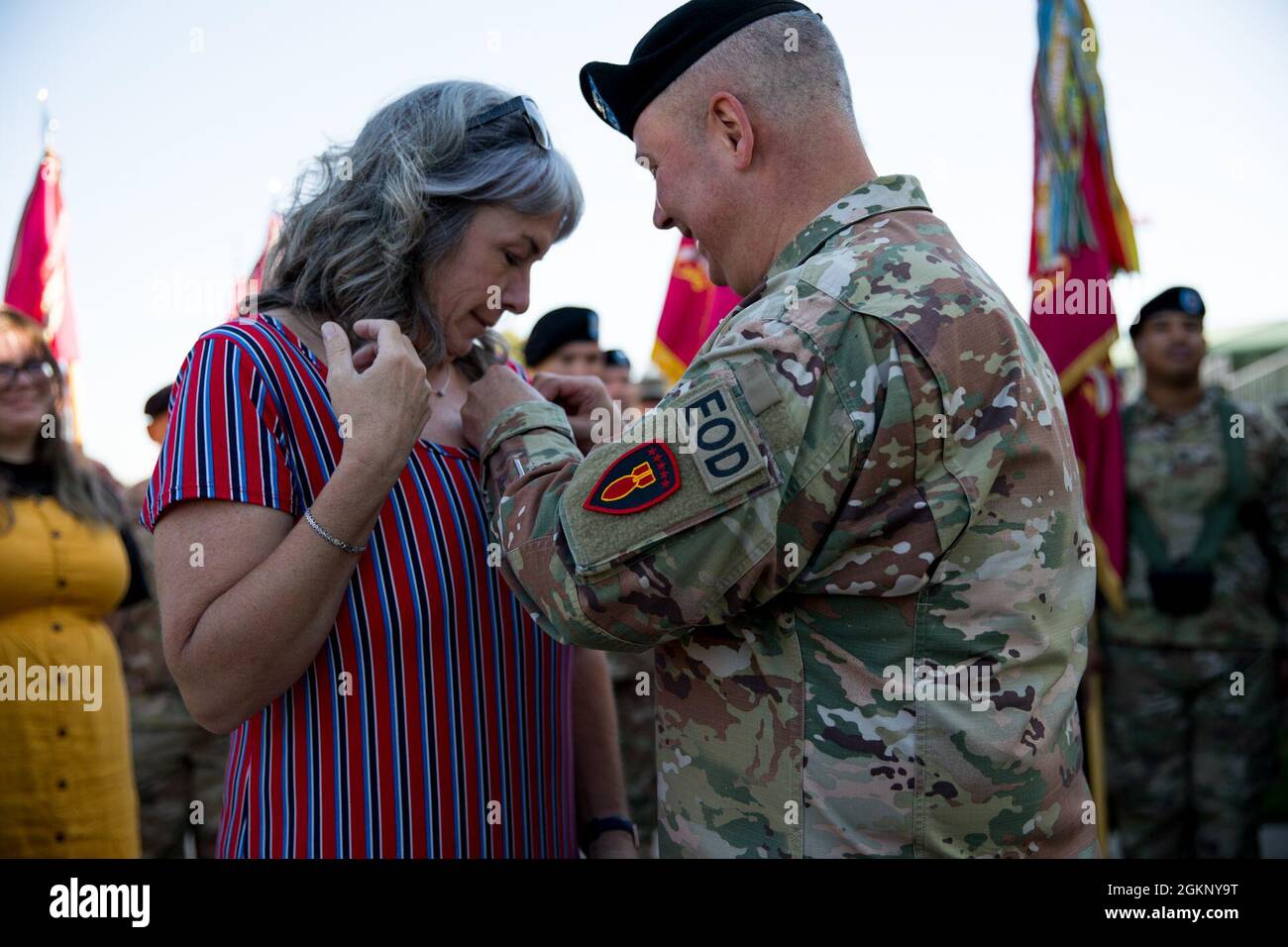 Col. David K. Green pins an award for his wife, Stacey Green during an ...