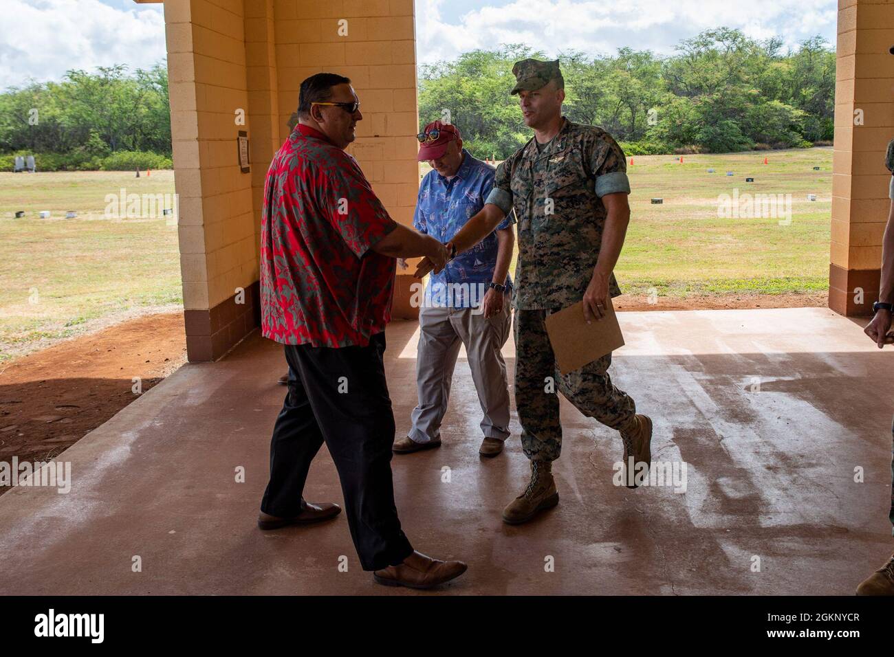 Kurt Fevella, state senator, Hawaii, is greeted by U.S. Marine Corps Lt ...