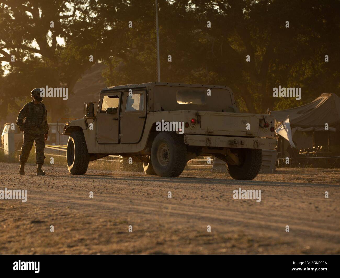 A Solider approaches a high mobility multipurpose wheeled vehicle ...