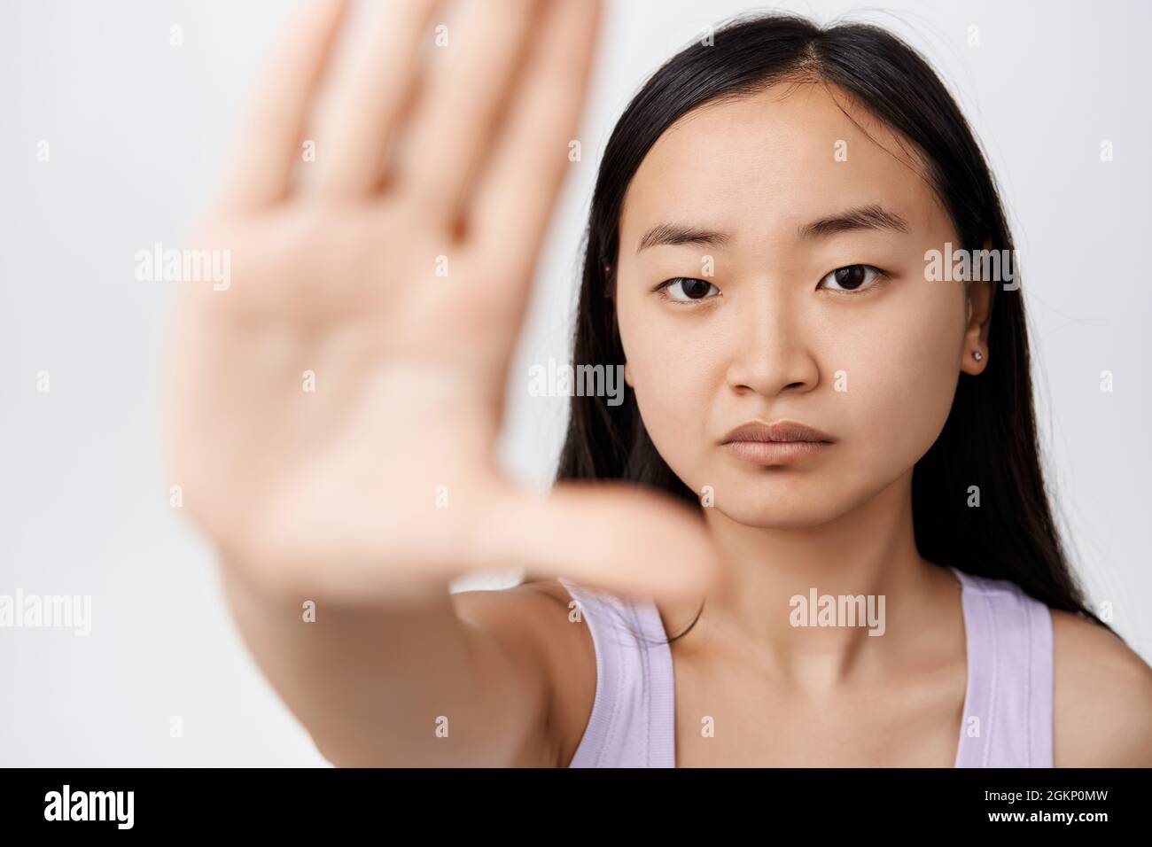 Close up portrait of serious korean woman stretch out hand, showing ...