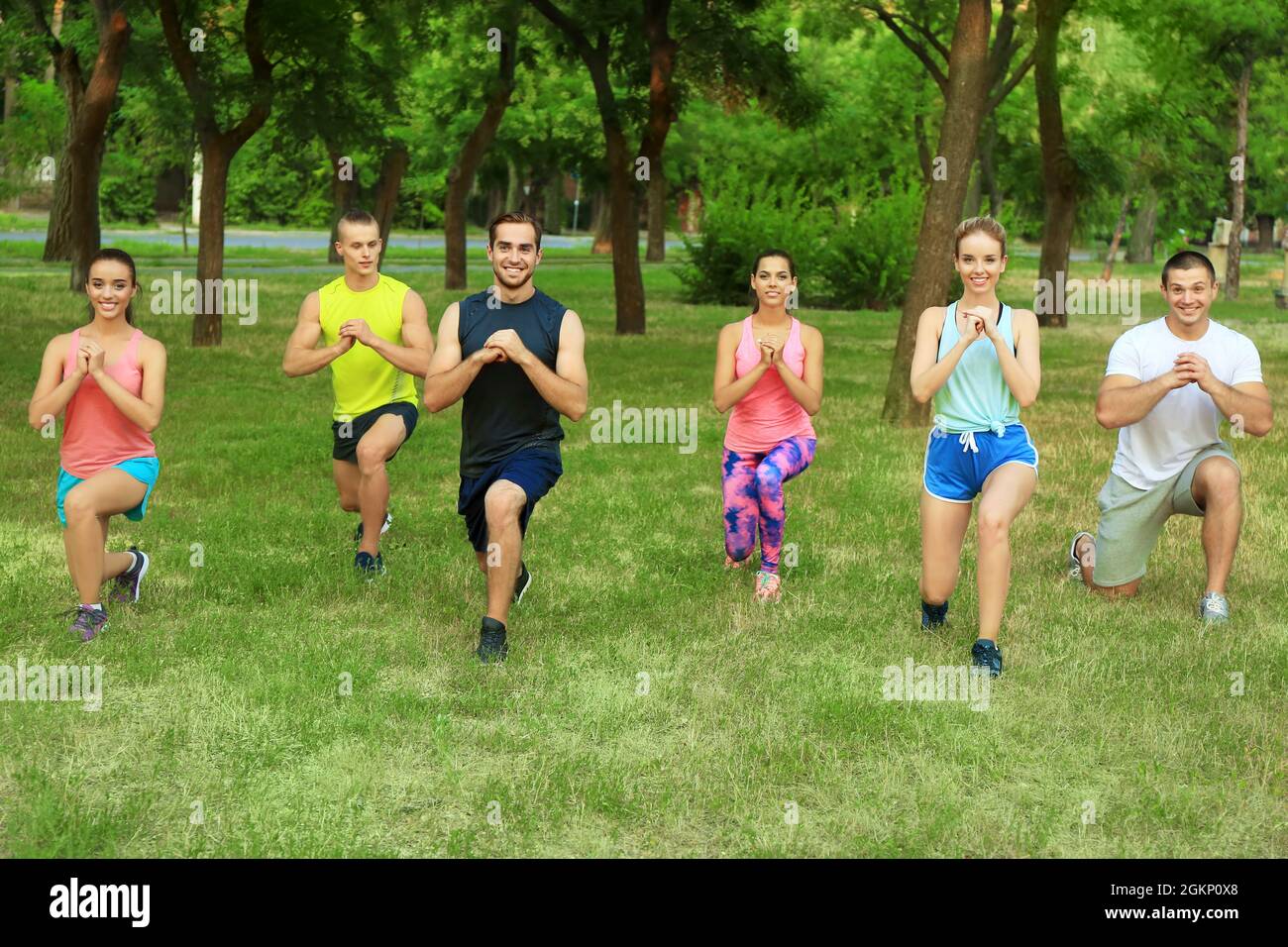 Group of young people doing exercise outdoors Stock Photo - Alamy