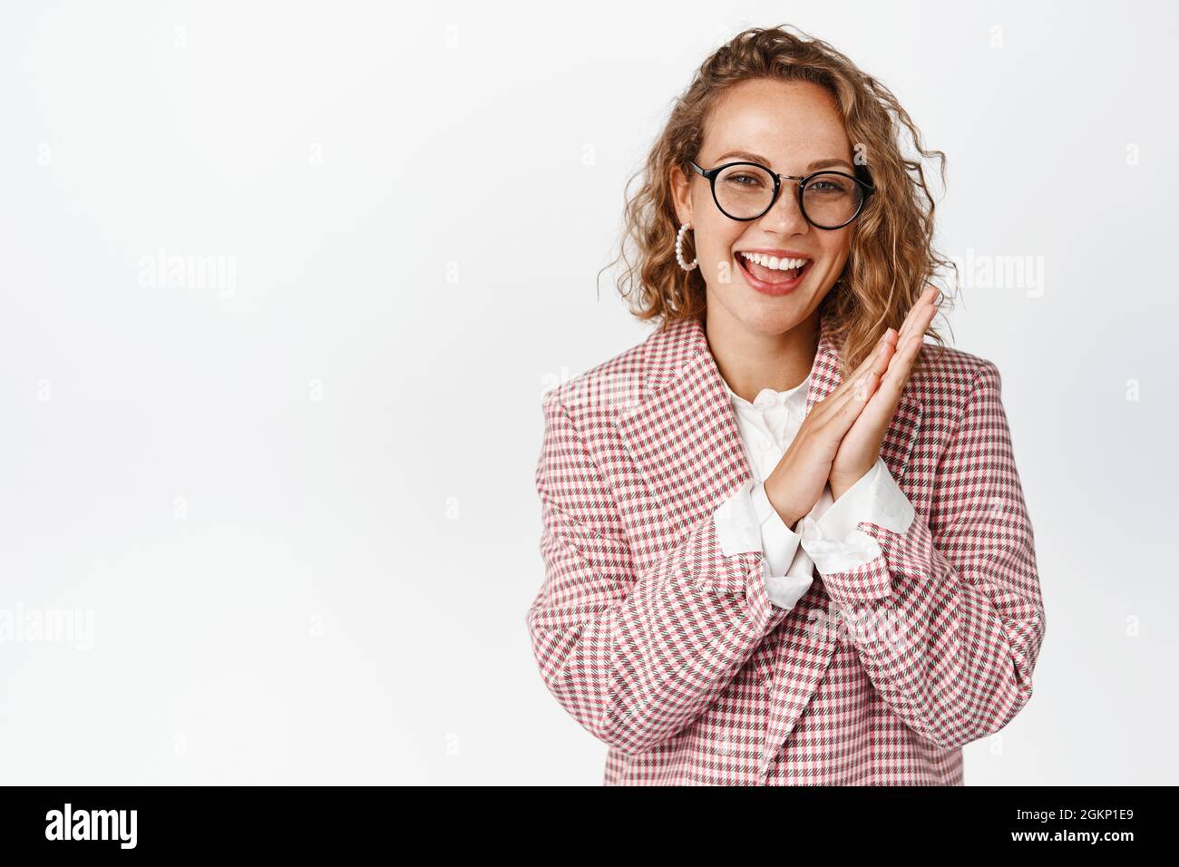 Image of businesswoman in glasses and suit clap hands, smiling and ...