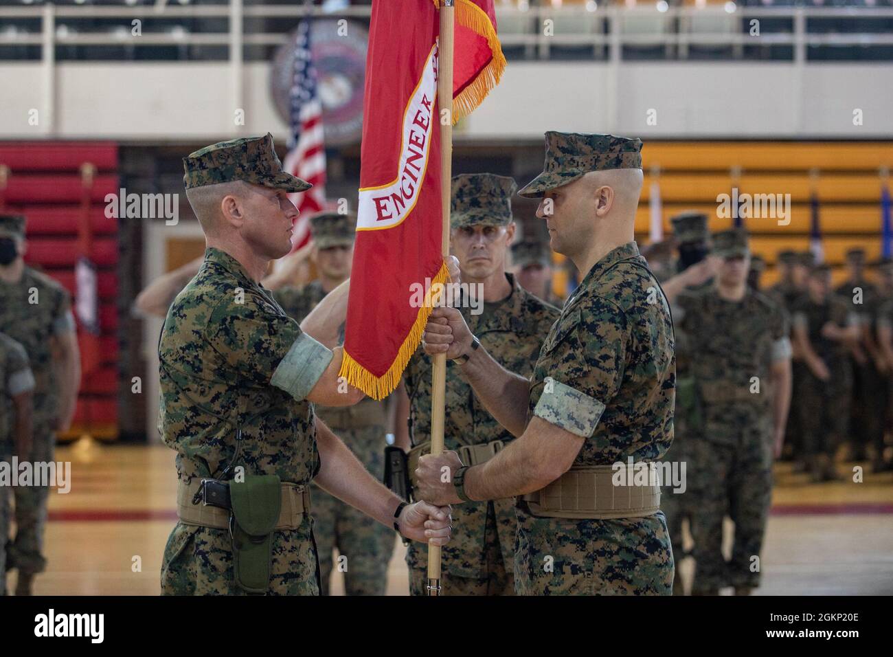 U.S. Marine Corps Lt. Col. Brandon E. Cooley, left, receives the ...