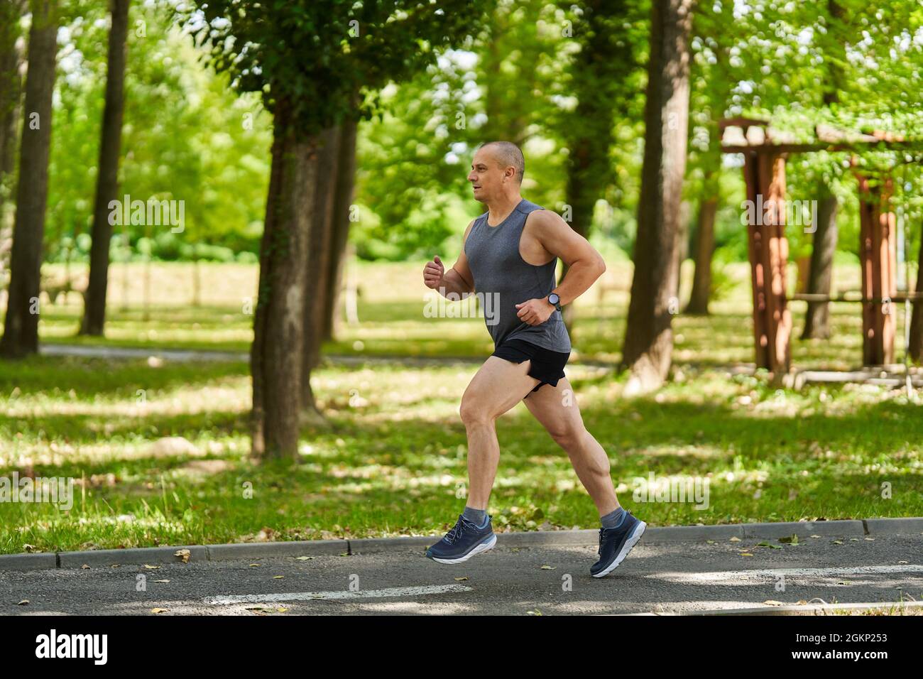 Athletic man marathon runner training in the park alleys Stock Photo ...