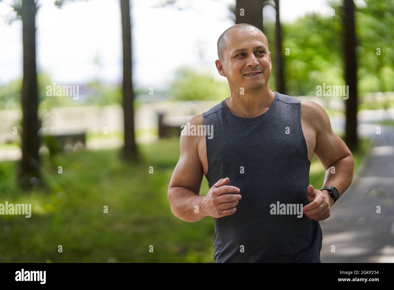 Athletic man marathon runner training in the park alleys Stock Photo ...