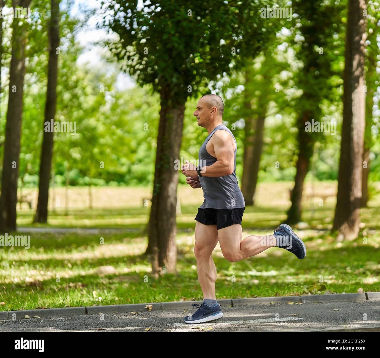 Athletic man marathon runner training in the park alleys Stock Photo ...