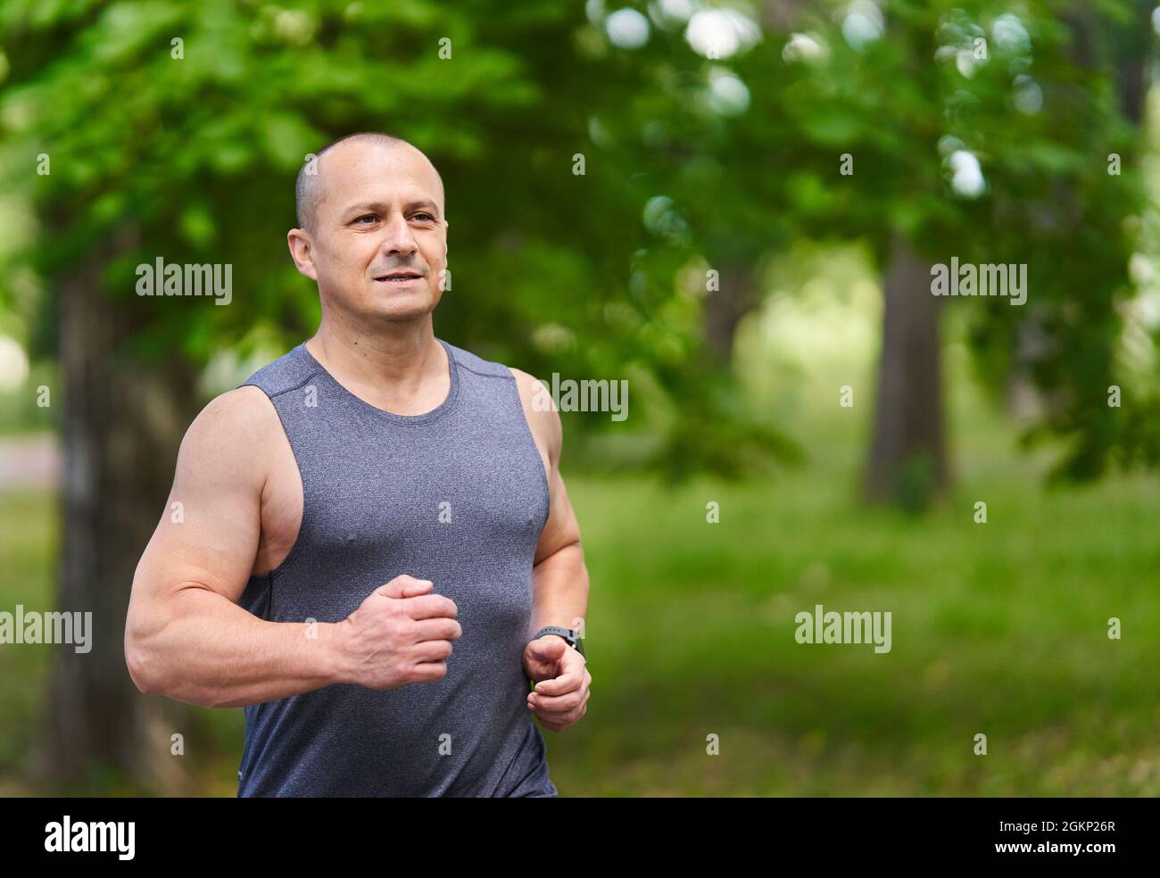 Athletic man marathon runner training in the park alleys Stock Photo ...