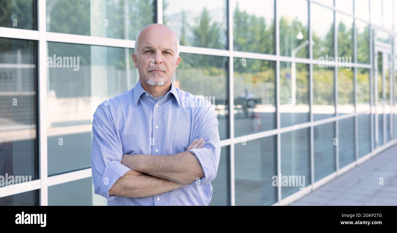 Serious self confident teacher stands hi-res stock photography and ...