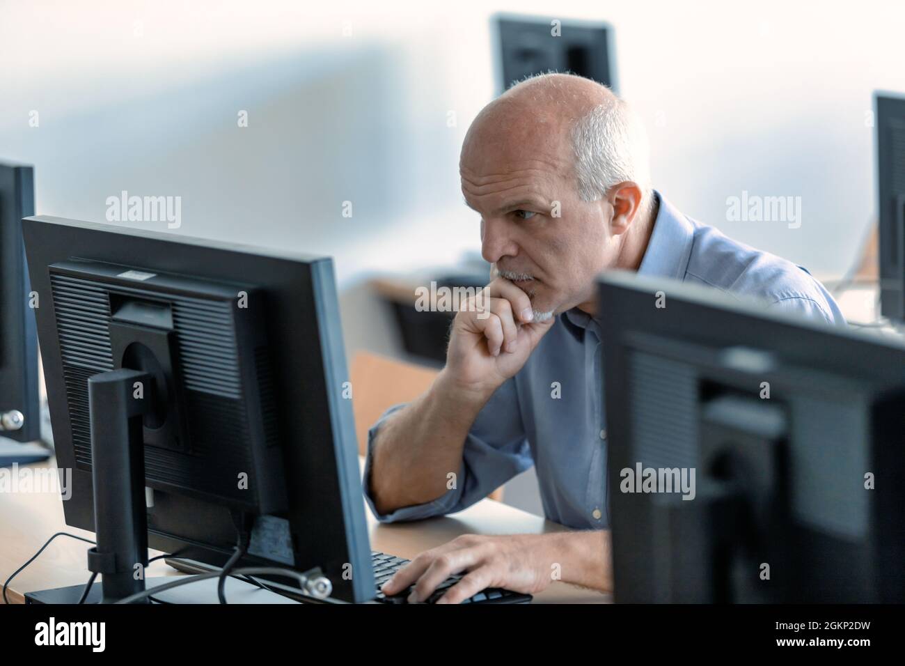 Hardworking businessman concentrating on his desktop computer leaning ...