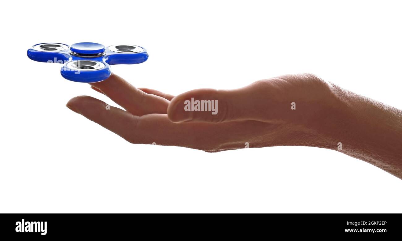 Man holding modern spinner on white background Stock Photo - Alamy