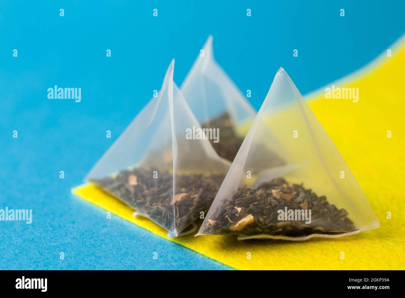 healthy green tea in a pyramid bag on a blue and yellow background ...