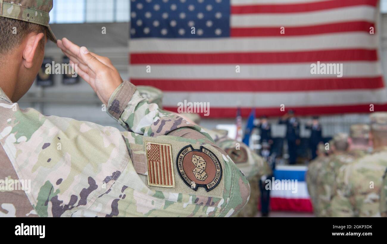 A member of the 65th Special Operations Squadron renders a salute ...