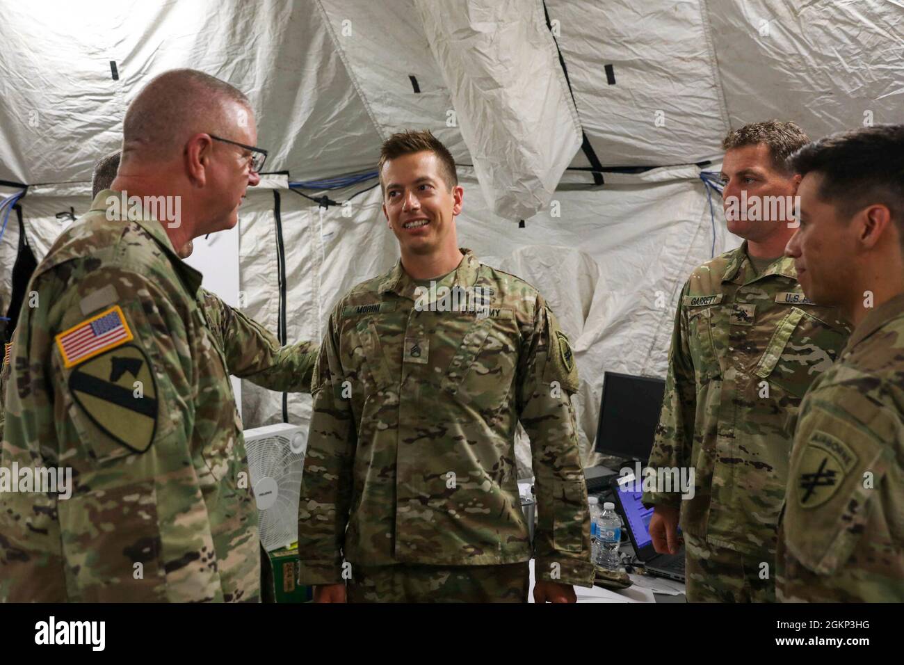 U.S. Army Reserve Staff Sgt. Michael R. Moroni (center), psychological ...
