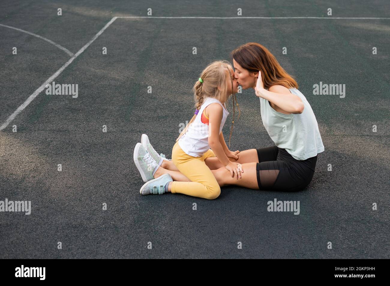 Mother and daughter go in for sports outdoors. Caucasian woman and ...