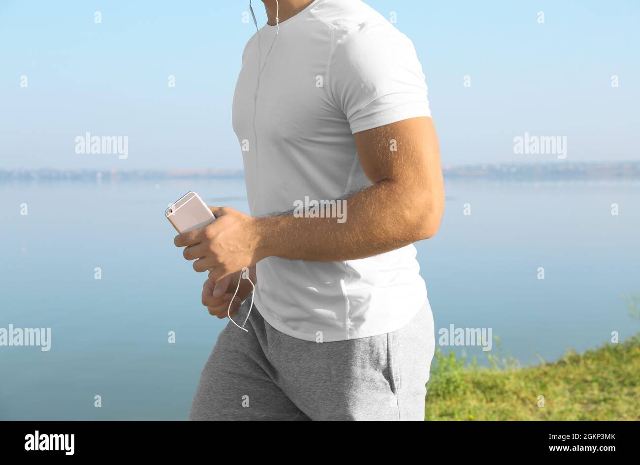 Handsome sporty man running outdoors Stock Photo - Alamy