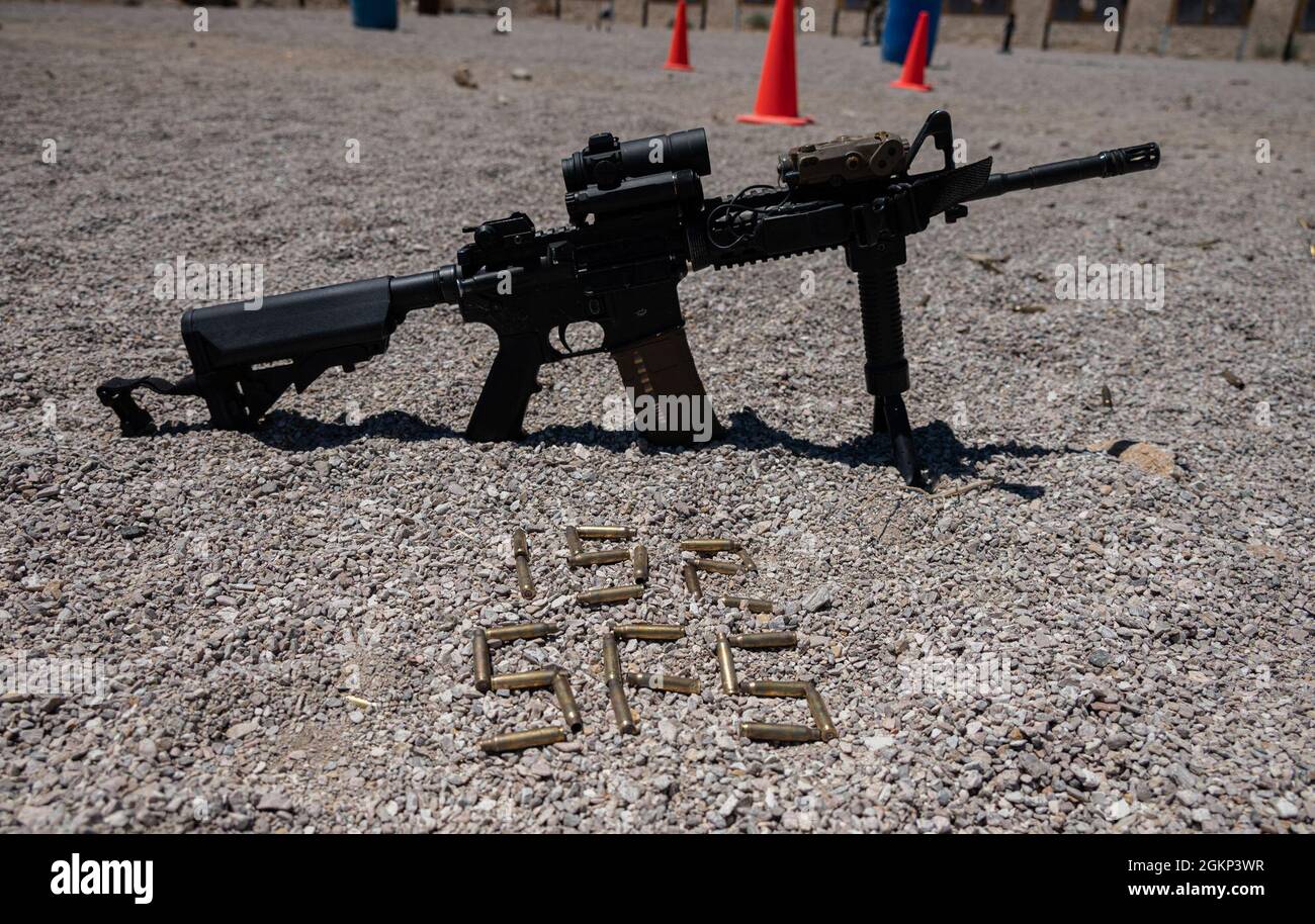 A M-4 carbine is set near spent 5.56 mm ammunition casings that spell ...