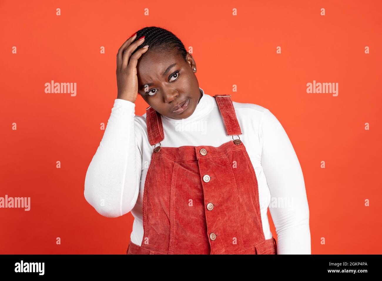 Bright portrait of African sad woman isolated on red studio background ...