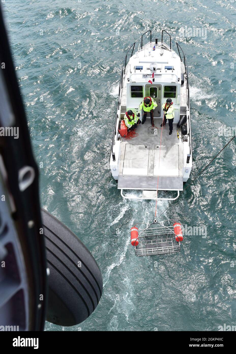 Boat crew members from the Ontario Provincial Police tend the trail ...