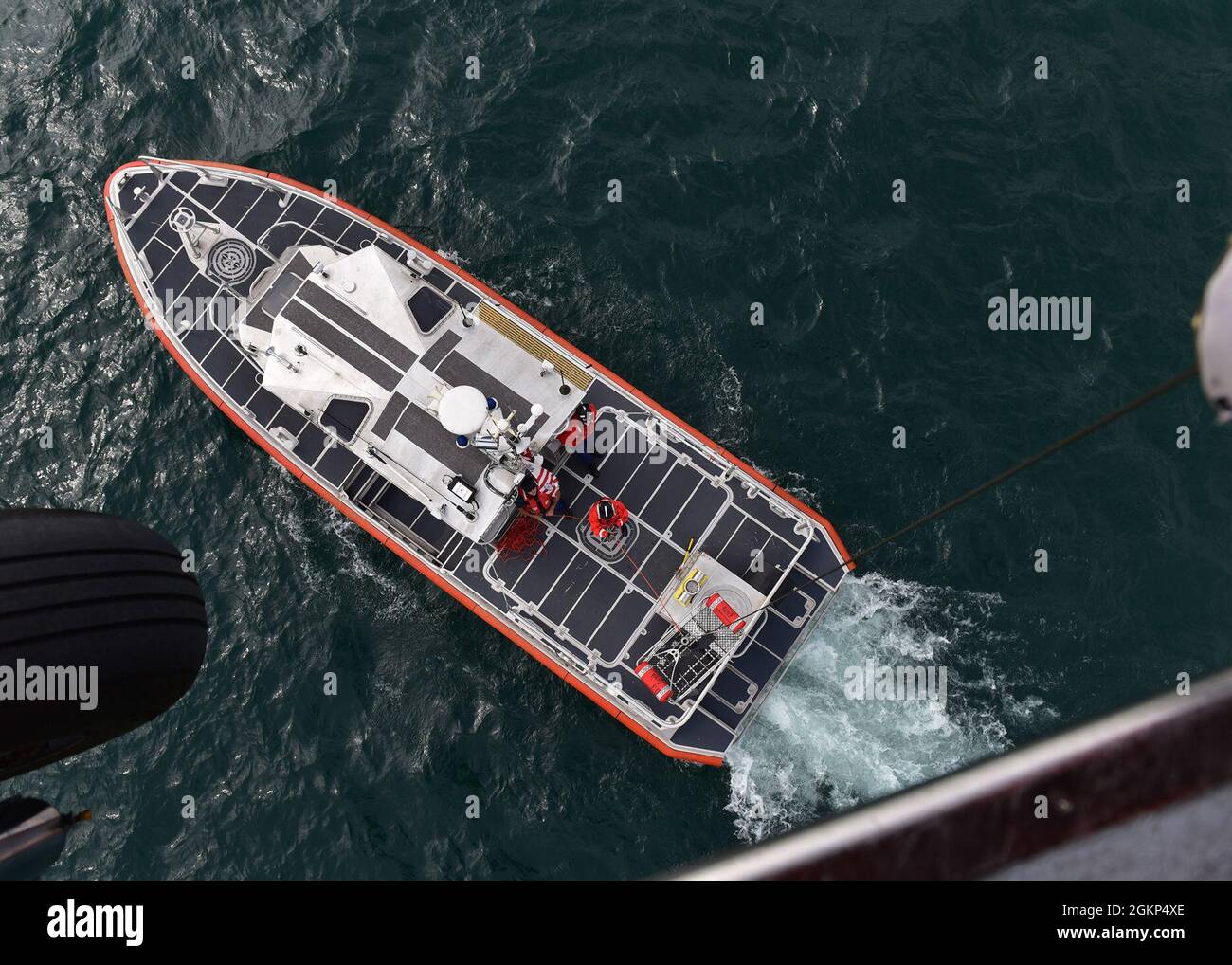 Boat crew members from Station Sault Ste. Marie, Mich., tend the trail ...