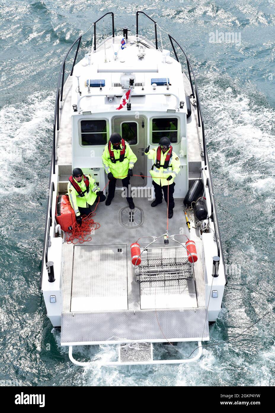 Boat crew members from the Ontario Provincial Police tend the trail ...