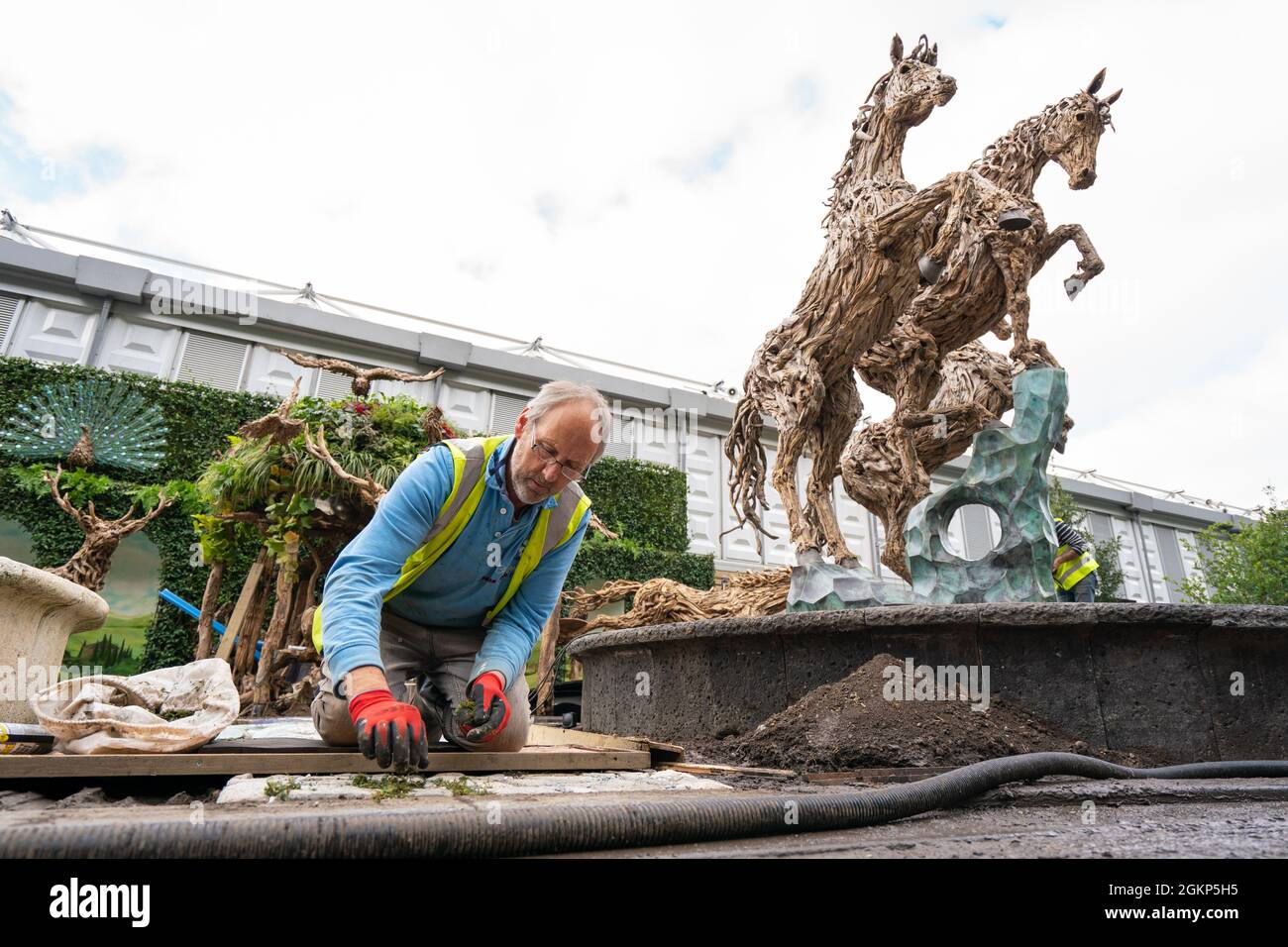 A gardener lays moss on a pathway at the James Doran-Webb Driftwood ...