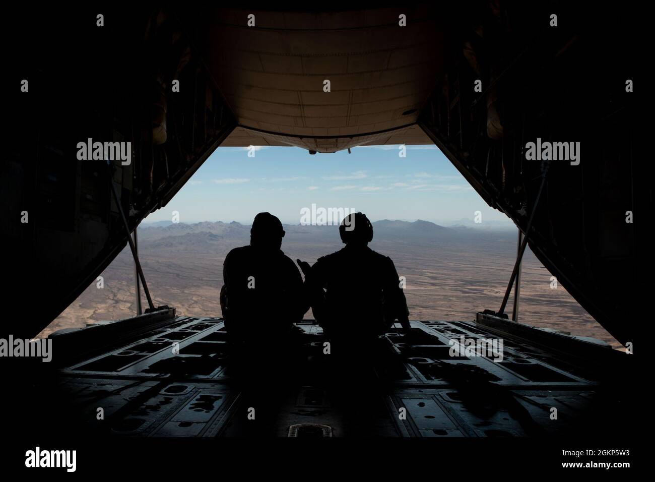 Loadmasters from the 79th Rescue Squadron watch as a U.S. Air Force HC ...