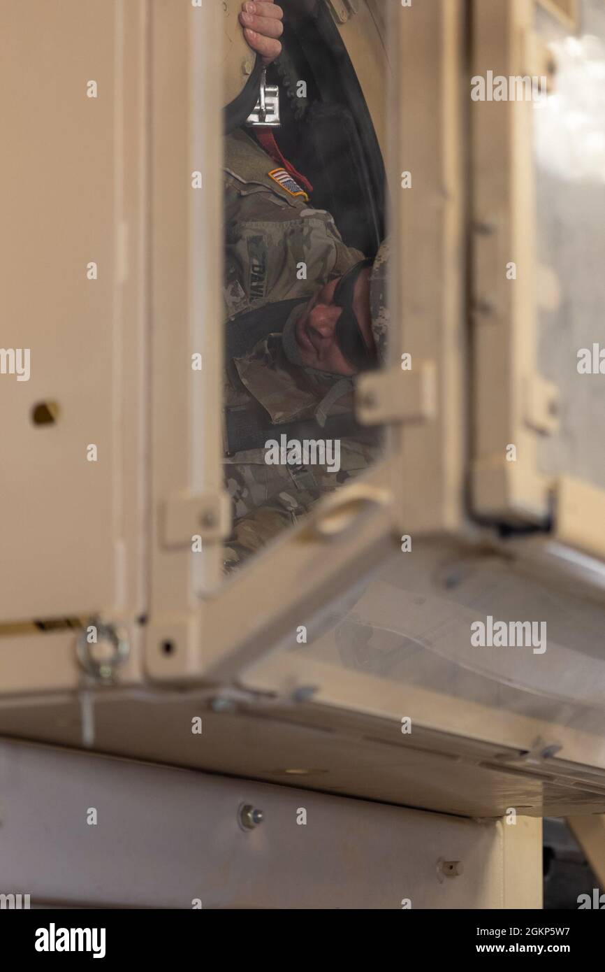 A soldier braces himself inside of a humvee rollover simulator while ...