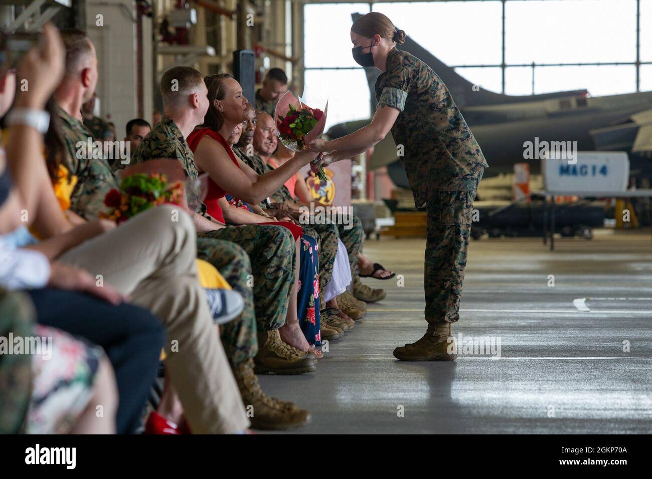 A U.S. Marine from Marine Attack Squadron (VMA) 223 delivers flowers to ...