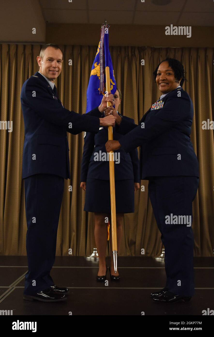 Col. Johnathan Compton, 319th Medical Group commander, passes the guidon to Lt. Col. Gillian ...