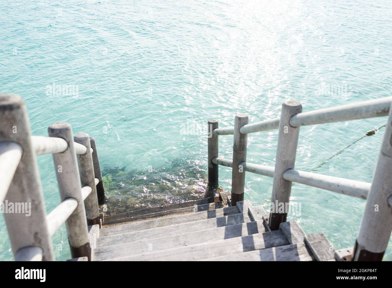 Beautiful tropical steps into turquoise sea water Stock Photo - Alamy