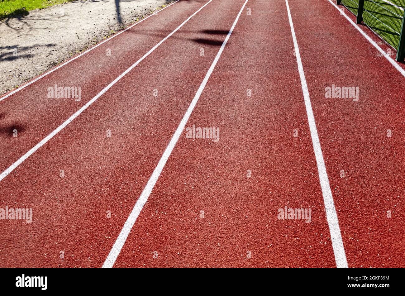 Red treadmill on sport field. Running track on the stadium Stock Photo ...