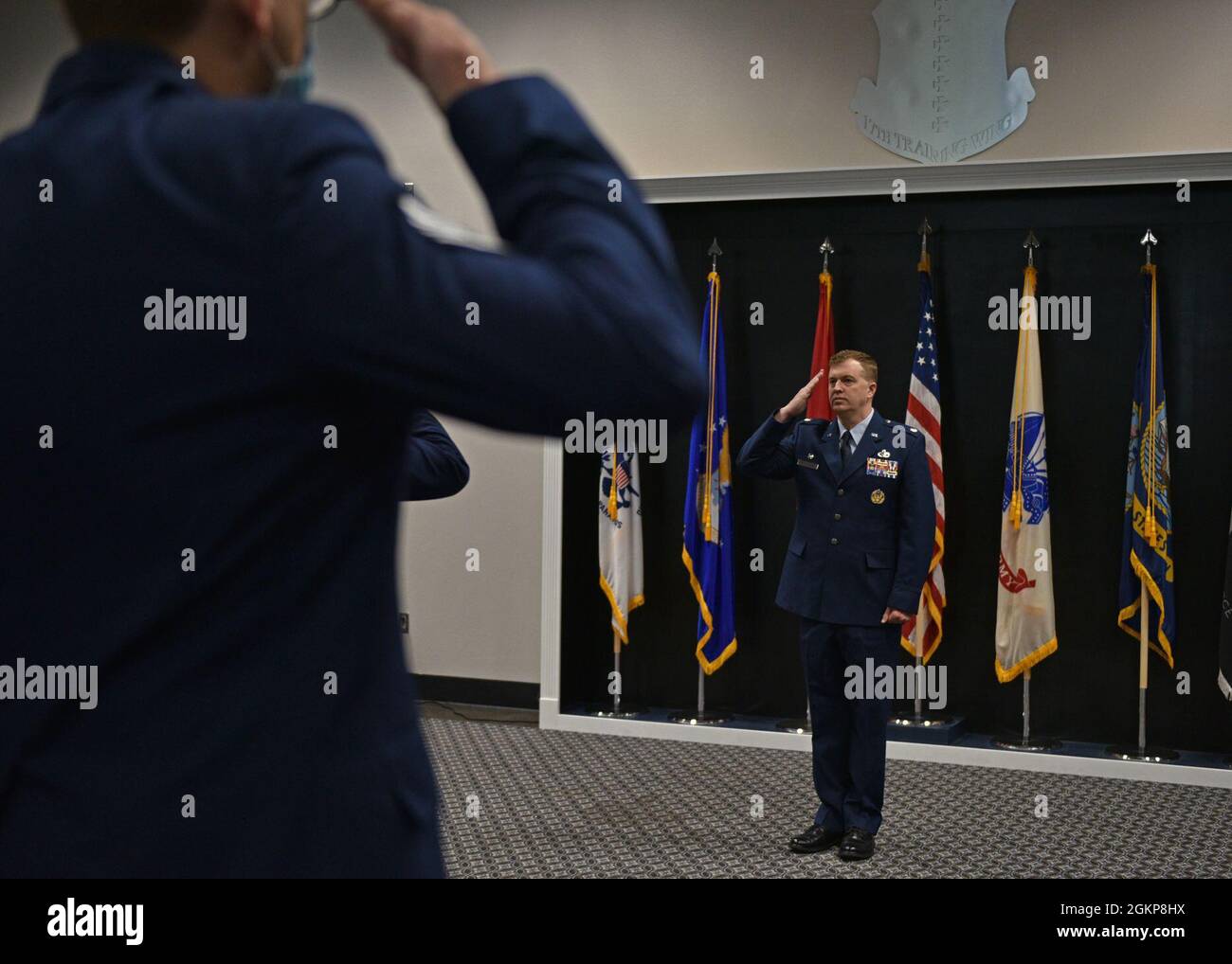 Members of the 313th Training Squadron salute U.S. Air Force Lt. Col ...